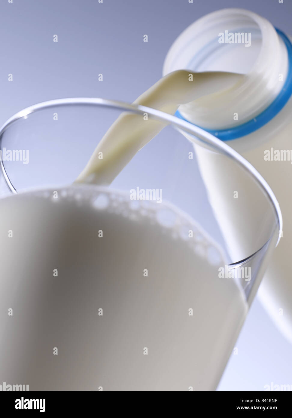 pouring milk into a glass Stock Photo - Alamy