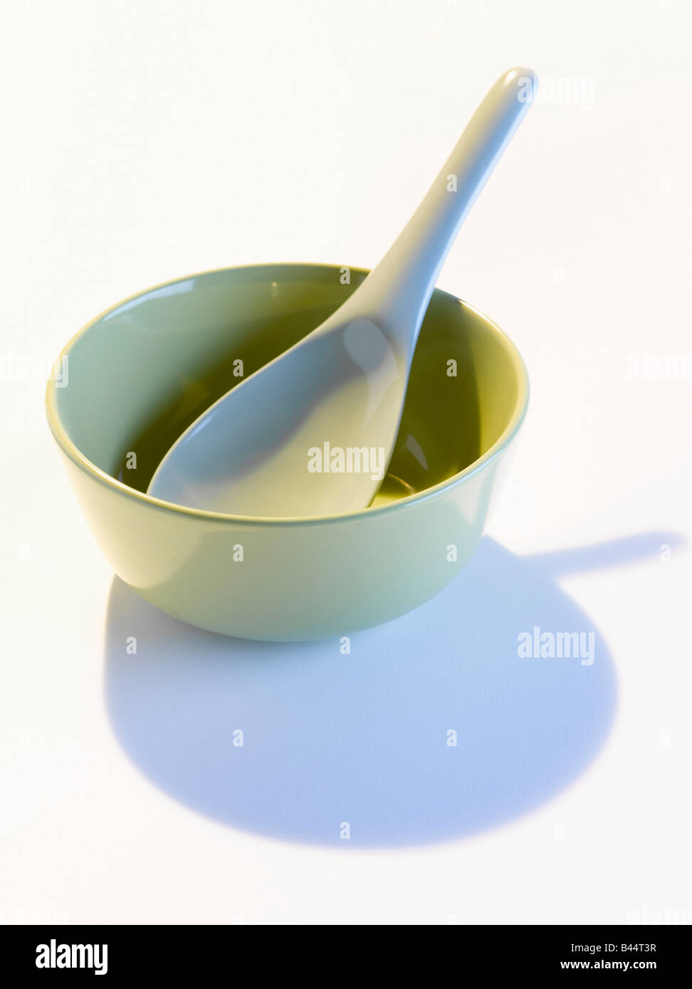 Spoon in small plastic bowl Stock Photo - Alamy