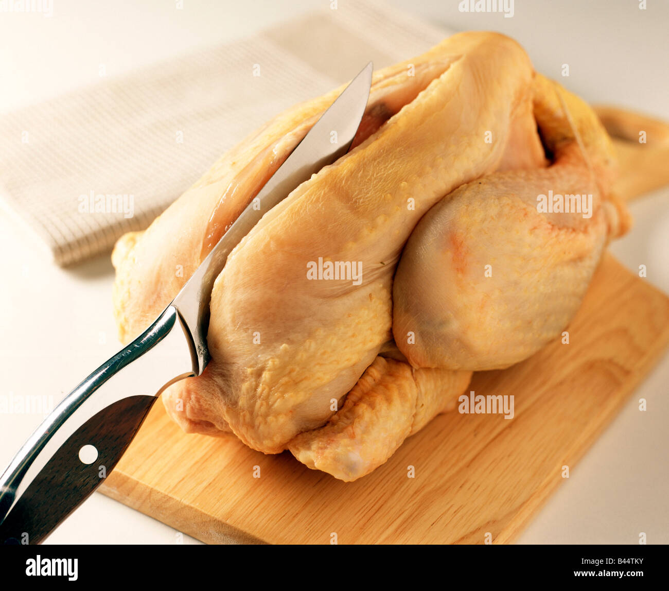 cutting raw chicken Stock Photo - Alamy