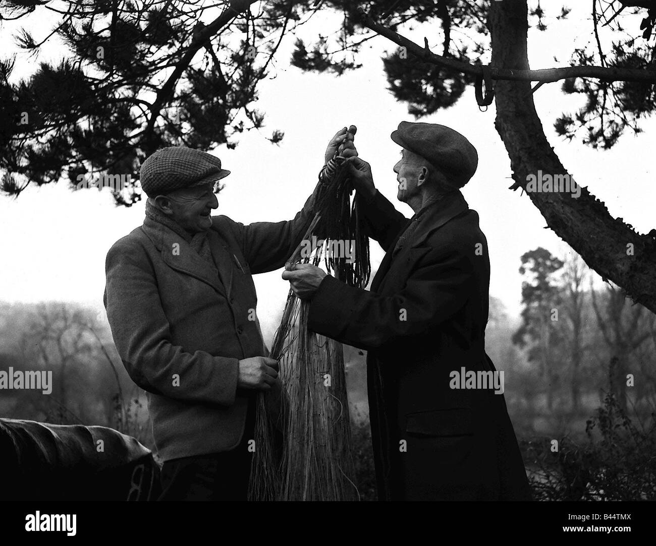 Coracle Fisherman sorting out their fishing nets 1952 Stock Photo - Alamy