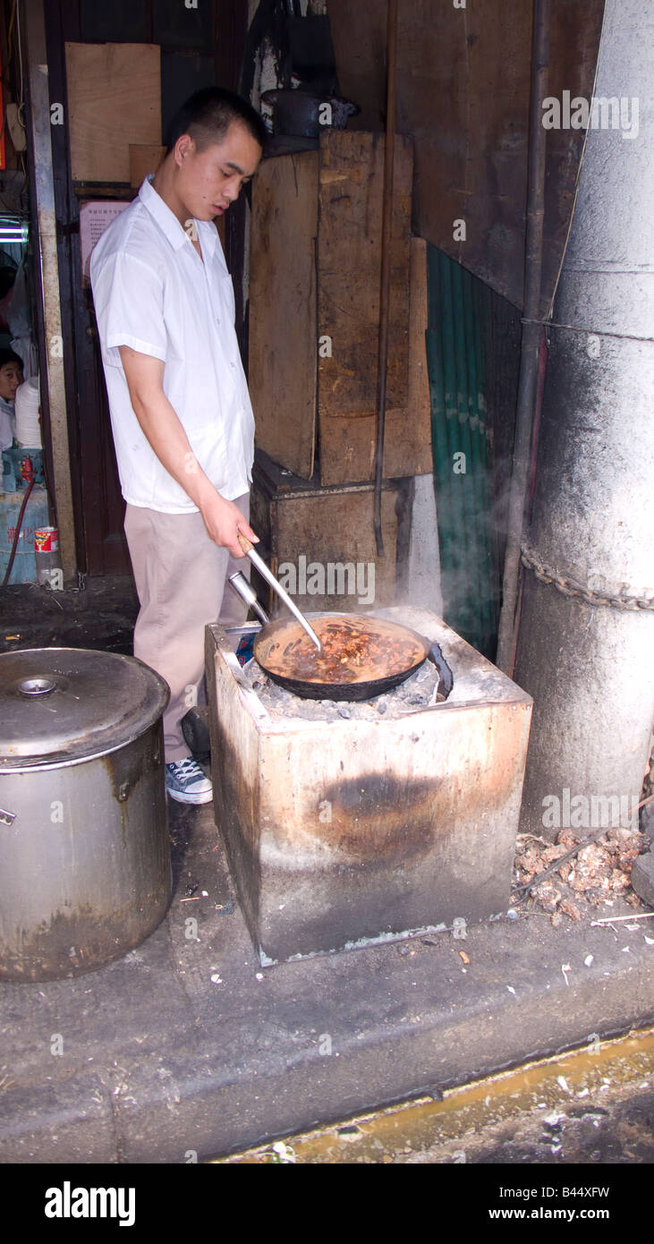 China Shanghai man cooking outdoors Stock Photo - Alamy
