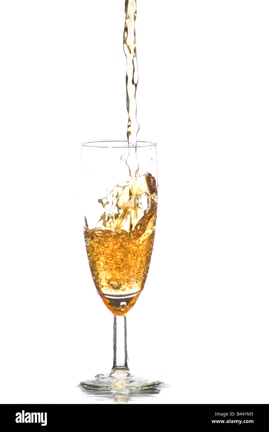 A photo of yellow liquid being poured into flute glass Stock Photo - Alamy