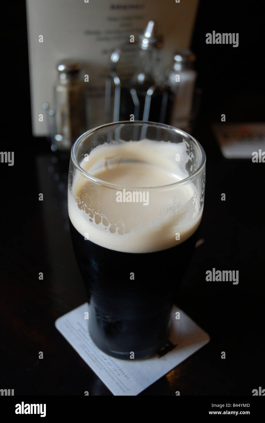 Partly drunk Pint of Stout on a table in a typical British pub Stock ...