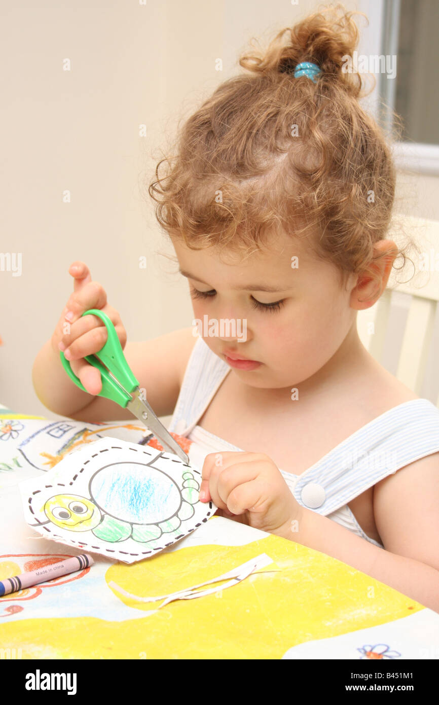 A little girl cutting out a picture Stock Photo - Alamy
