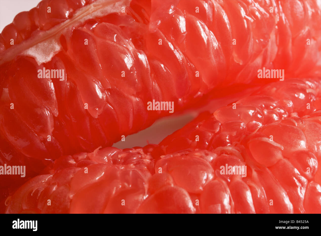 Two slices of red grapefruit arranged to look like kissing lips Stock ...