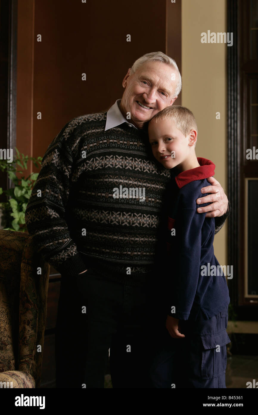 Grandfather hugging grandson Stock Photo - Alamy