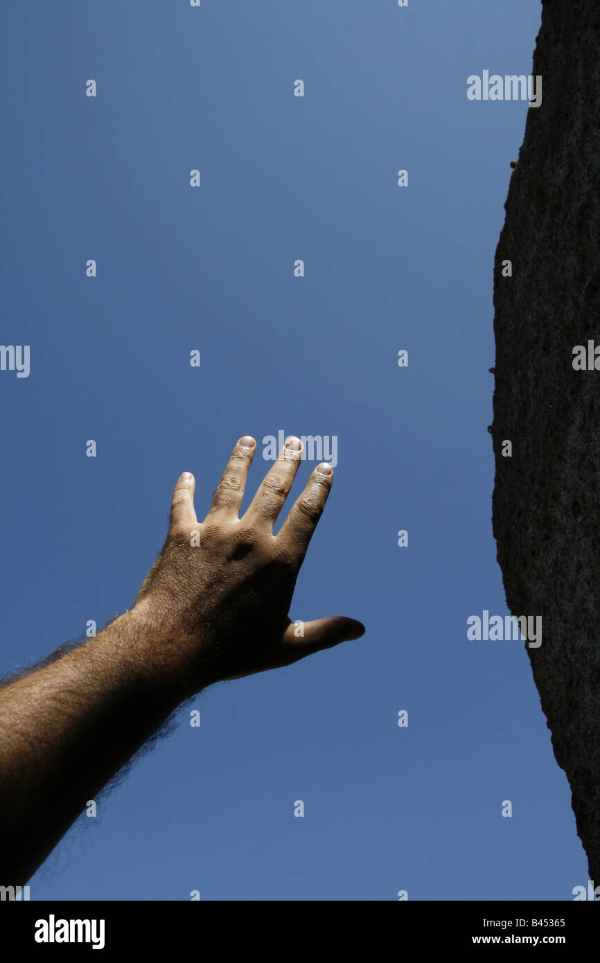 man's hand reaching out into clear blue sky Stock Photo - Alamy