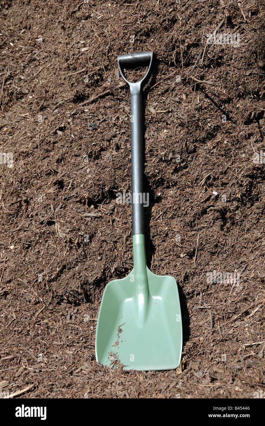 Plastic spade on compost heap Stock Photo - Alamy