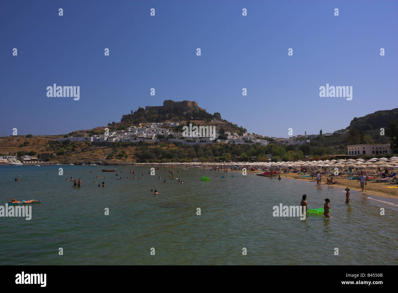 Above the modern town rises the acropolis of lindos hi-res stock ...