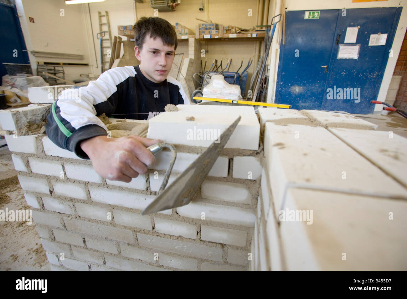 Trainee learning the bricklayer craft Stock Photo - Alamy