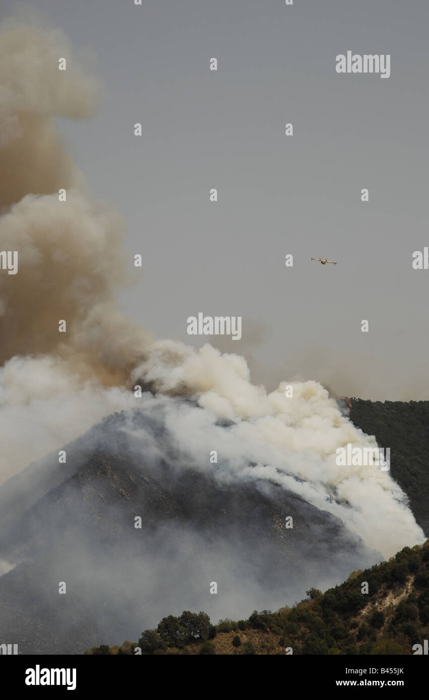 A very big fire is burning over a hill, which is completely surrounded ...