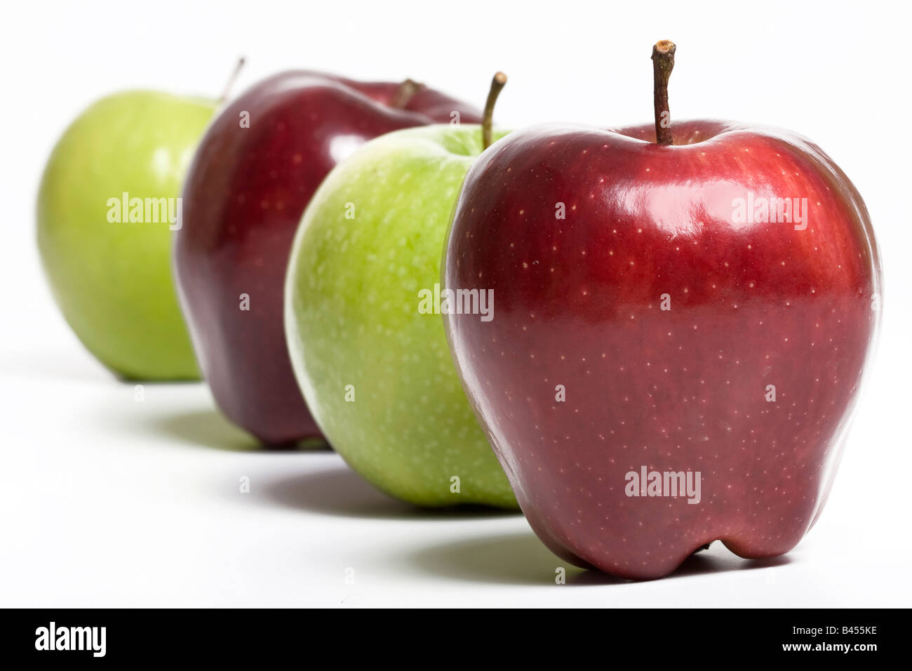 Four apples on a light background Stock Photo - Alamy