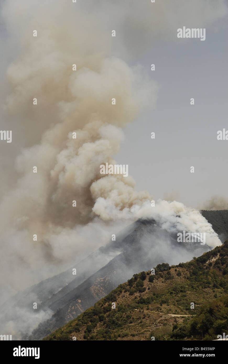 A very big fire is burning over a hill, which is completely surrounded ...
