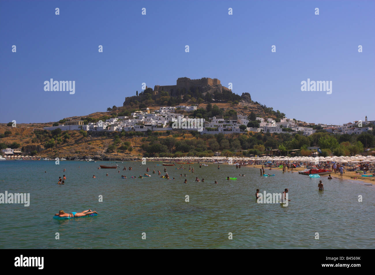Above the modern town rises the acropolis of lindos hi-res stock ...
