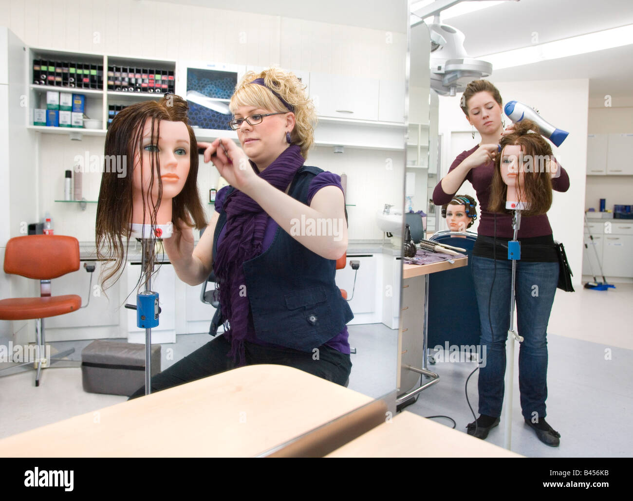 Trainees learning the hair dresser craft Stock Photo - Alamy