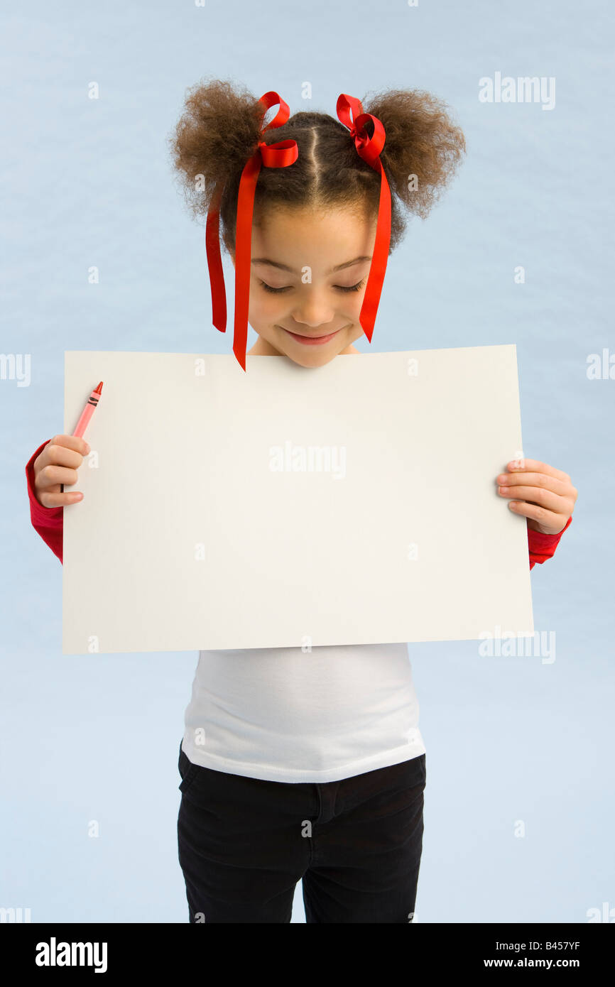 Girl holding up a book Stock Photo - Alamy