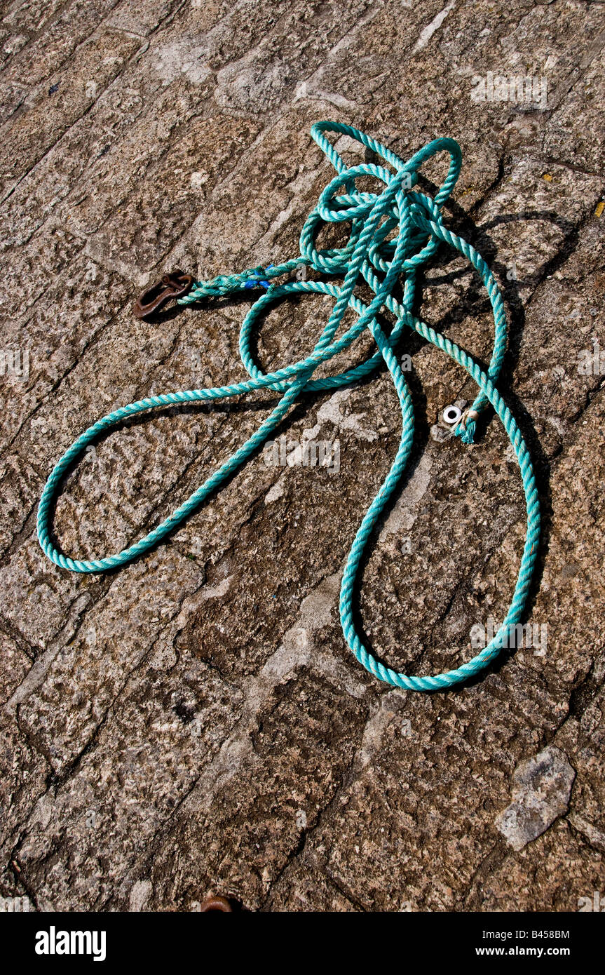 Rope lying on the ground Stock Photo - Alamy
