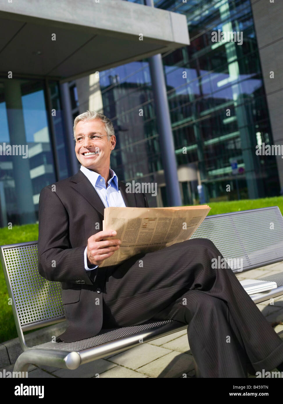 Germany, Baden-Württemberg, Stuttgart, Businessman holding newspaper ...