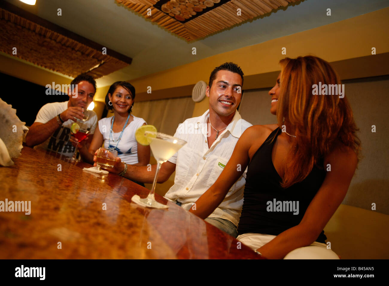 couples socializing at a bar Stock Photo - Alamy