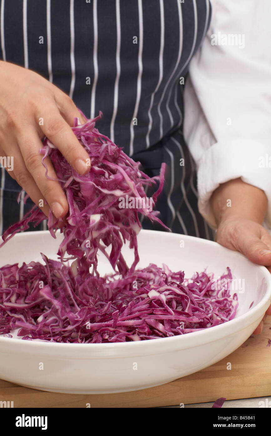 Mixing red cabbage, close-up Stock Photo - Alamy