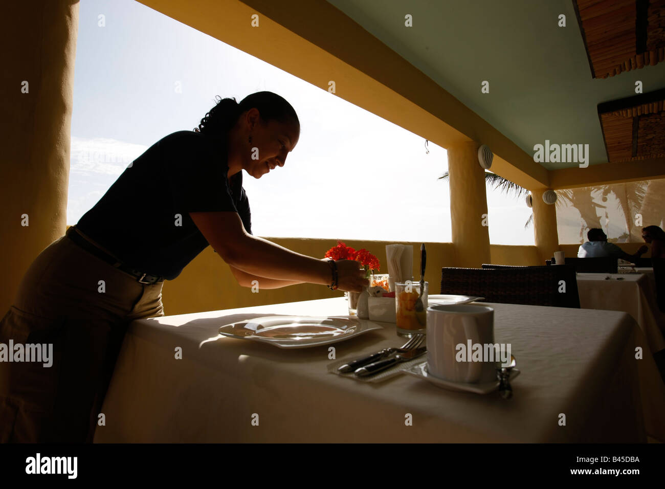 waitress setting table in a Caribbean tropical vacation resort Stock ...