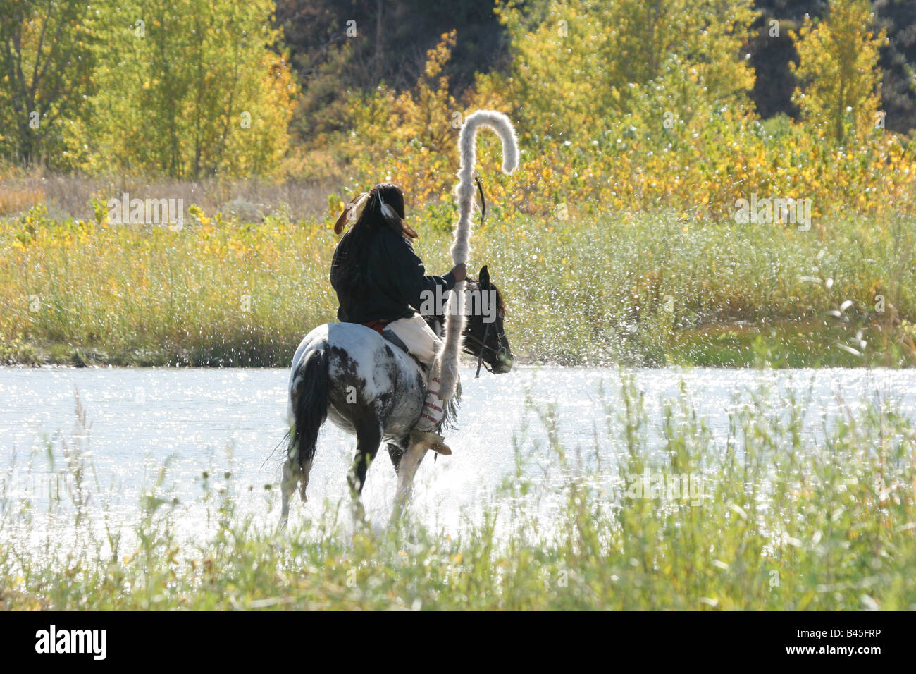 A Native American Sioux Indian on horseback riding his pony across a ...