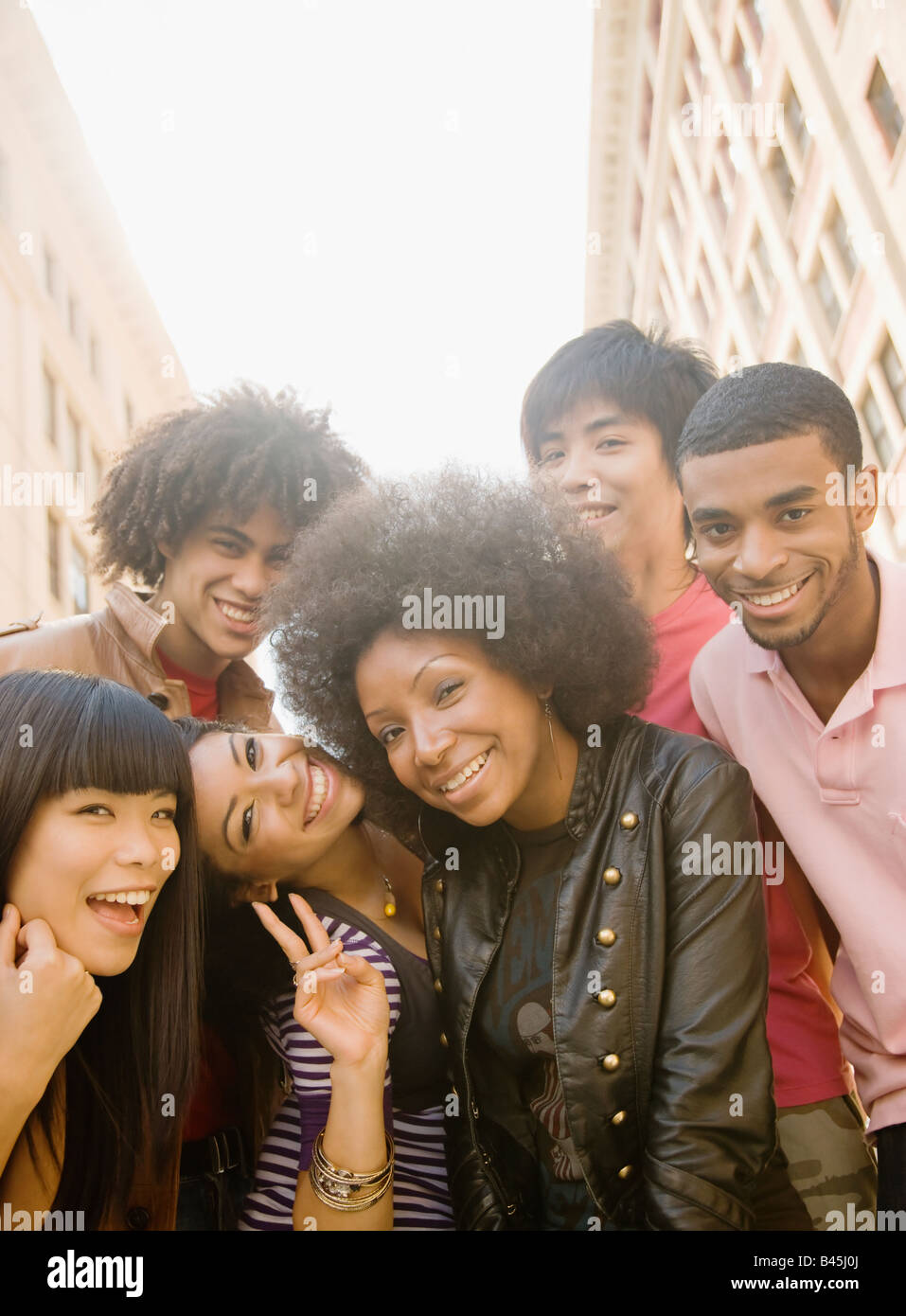 Multi-ethnic friends smiling Stock Photo - Alamy