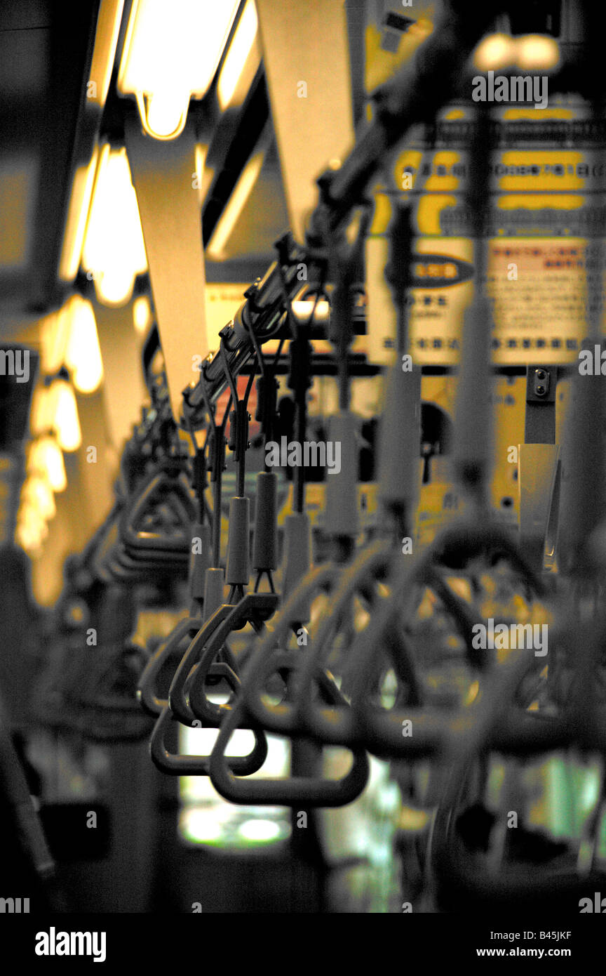 Hanging handles in a train at night Stock Photo - Alamy