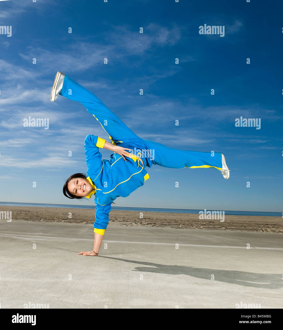 Asian woman balancing on one hand Stock Photo - Alamy