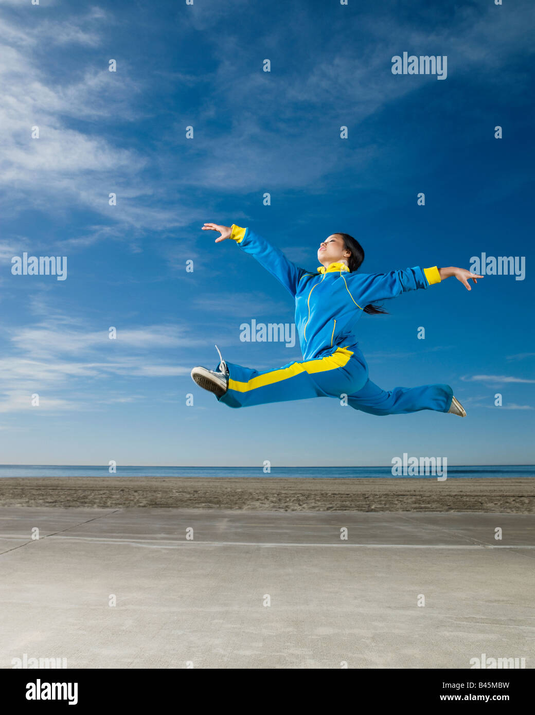 Asian woman jumping in air Stock Photo - Alamy