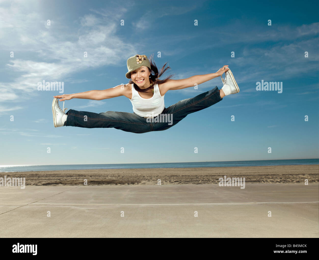Asian woman jumping in air Stock Photo - Alamy