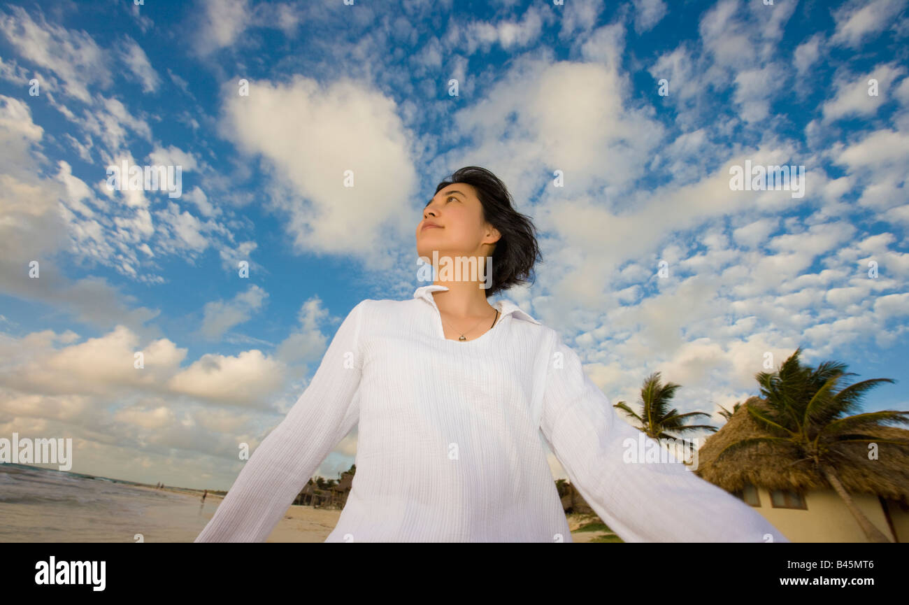 Asian woman walking under blue sky with clouds Stock Photo - Alamy