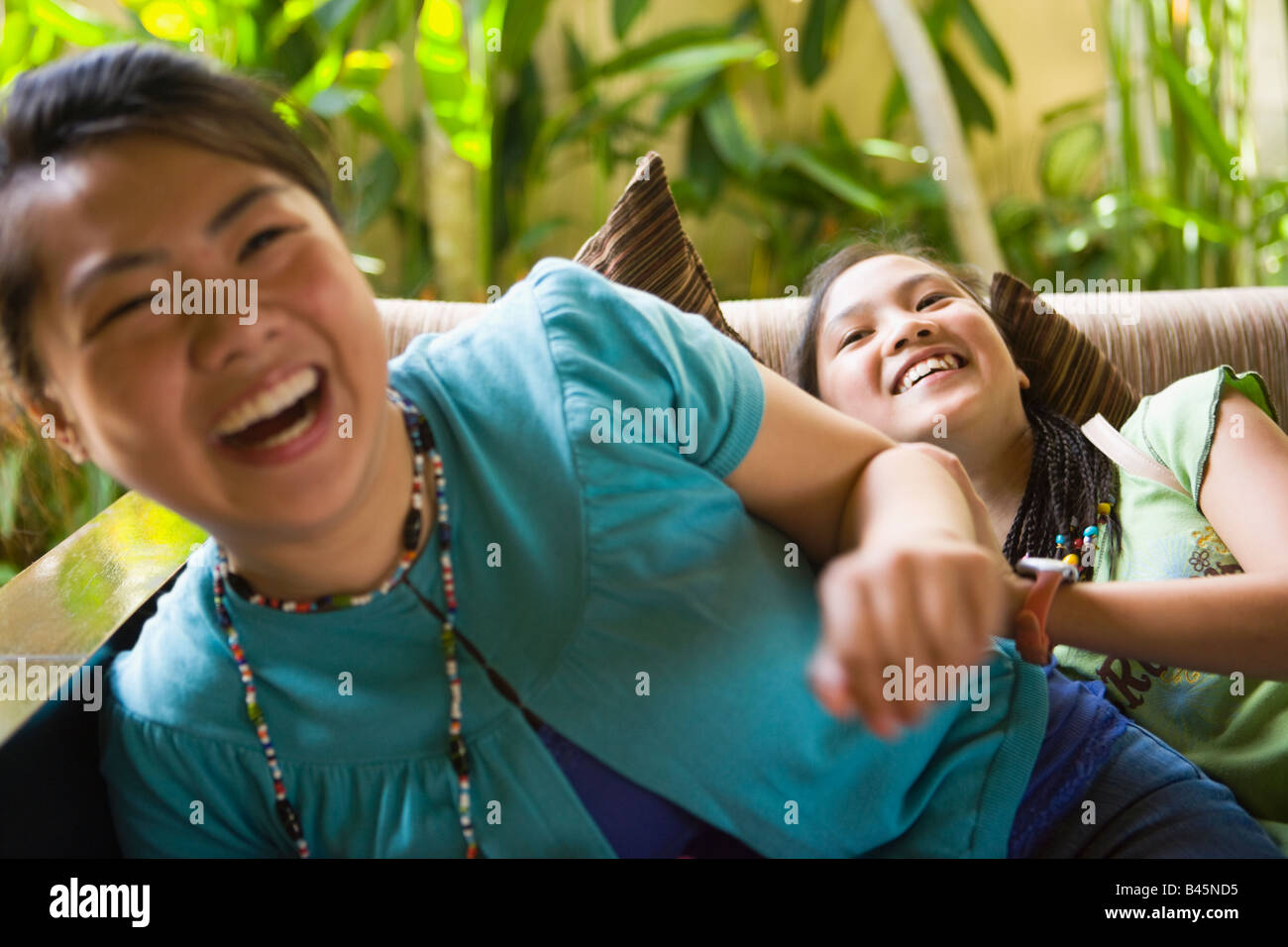 Asian friends laughing Stock Photo - Alamy