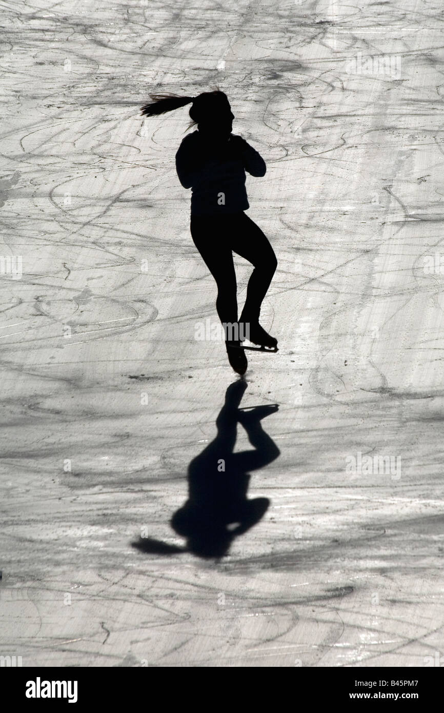 Silhouette of an ice skater spinning Stock Photo - Alamy
