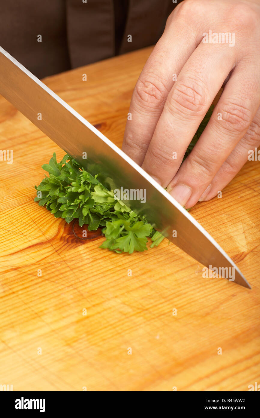 Chopping parsley, close-up Stock Photo - Alamy