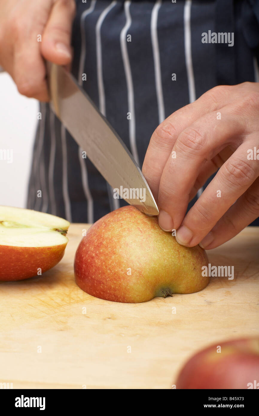 Person cutting an apple into quarters, close-up Stock Photo - Alamy
