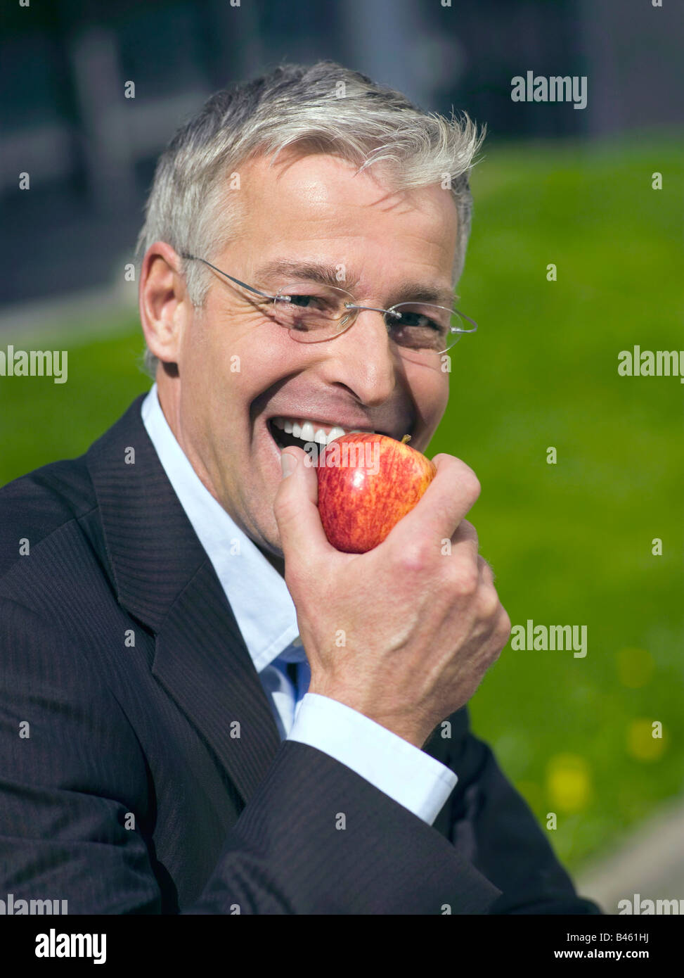 Mature man biting apple hi-res stock photography and images - Alamy