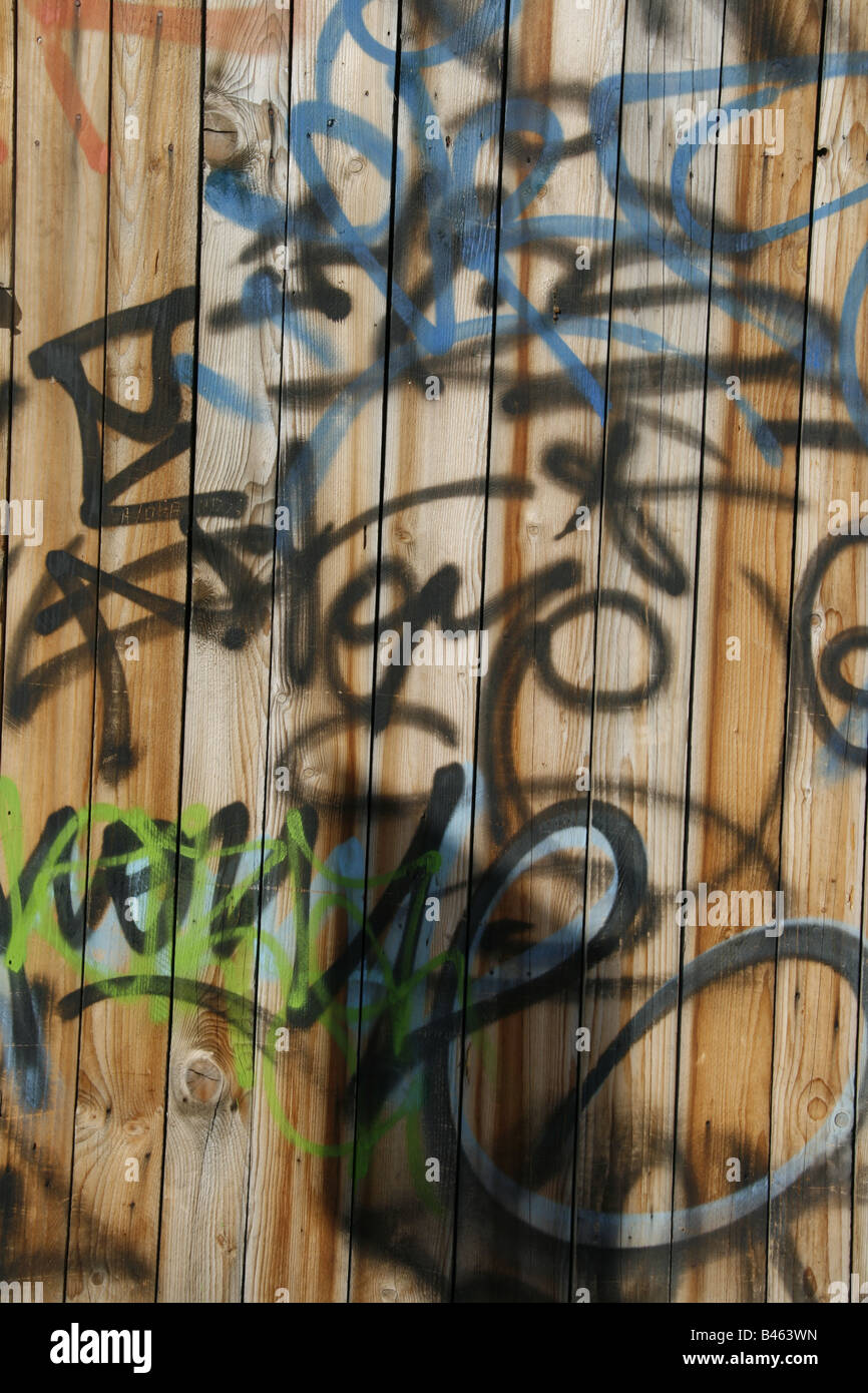 colourful urban graffiti on old wooden fence wall surface in sun ...