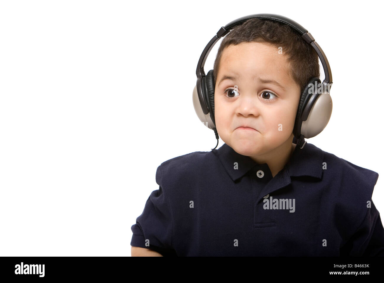 Sad boy with headphones not liking song choice Stock Photo - Alamy