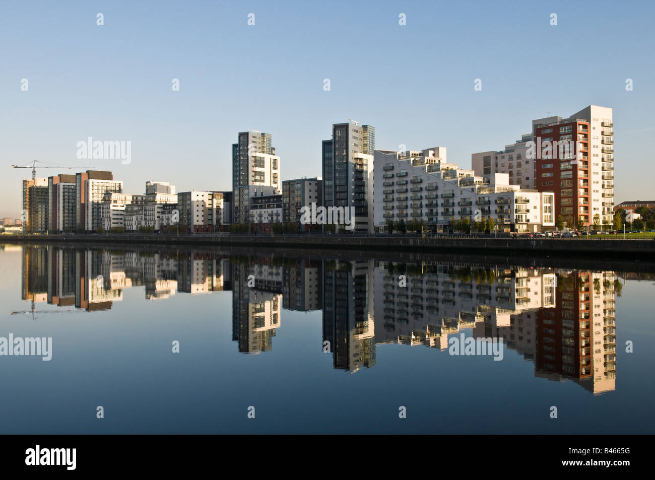 Residential buildings at Glasgow Harbour, reflected in the River Clyde ...