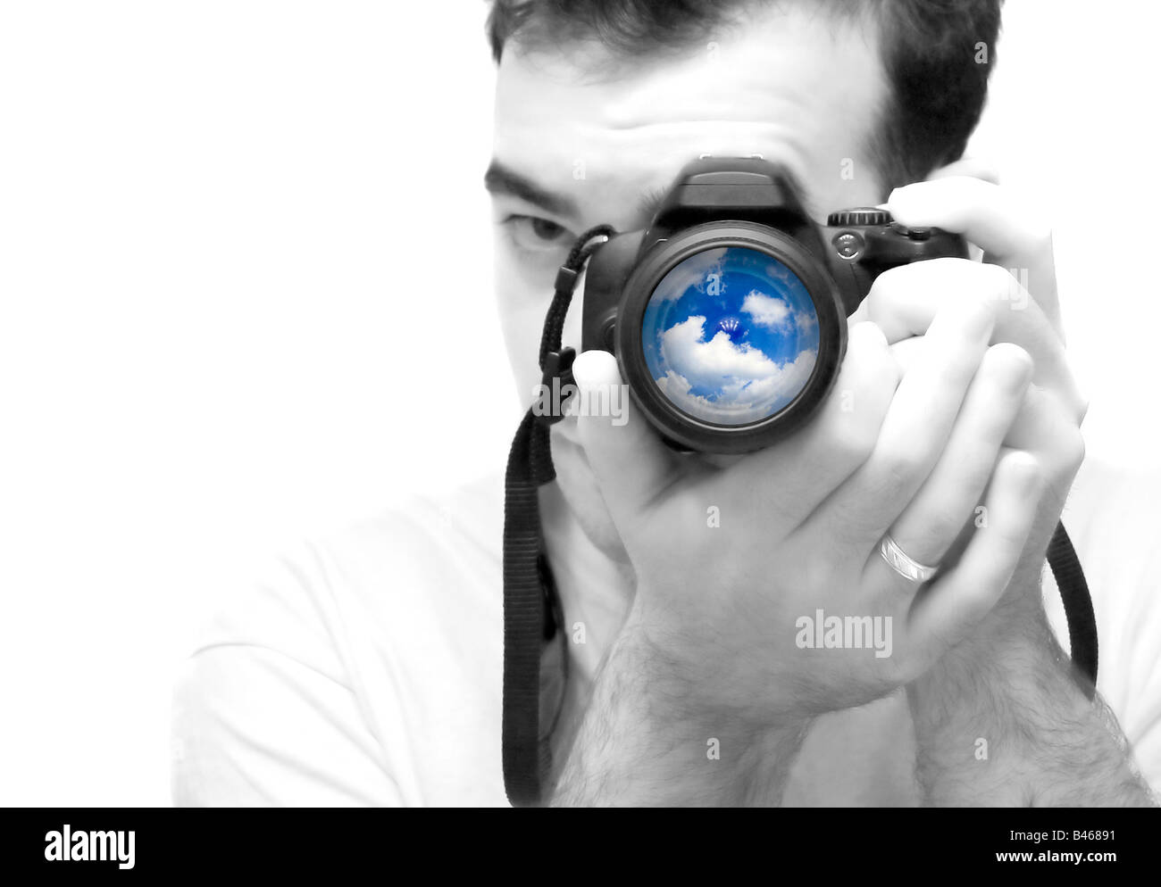 A young photographer taking a shot with his DSLR camera Selective color ...