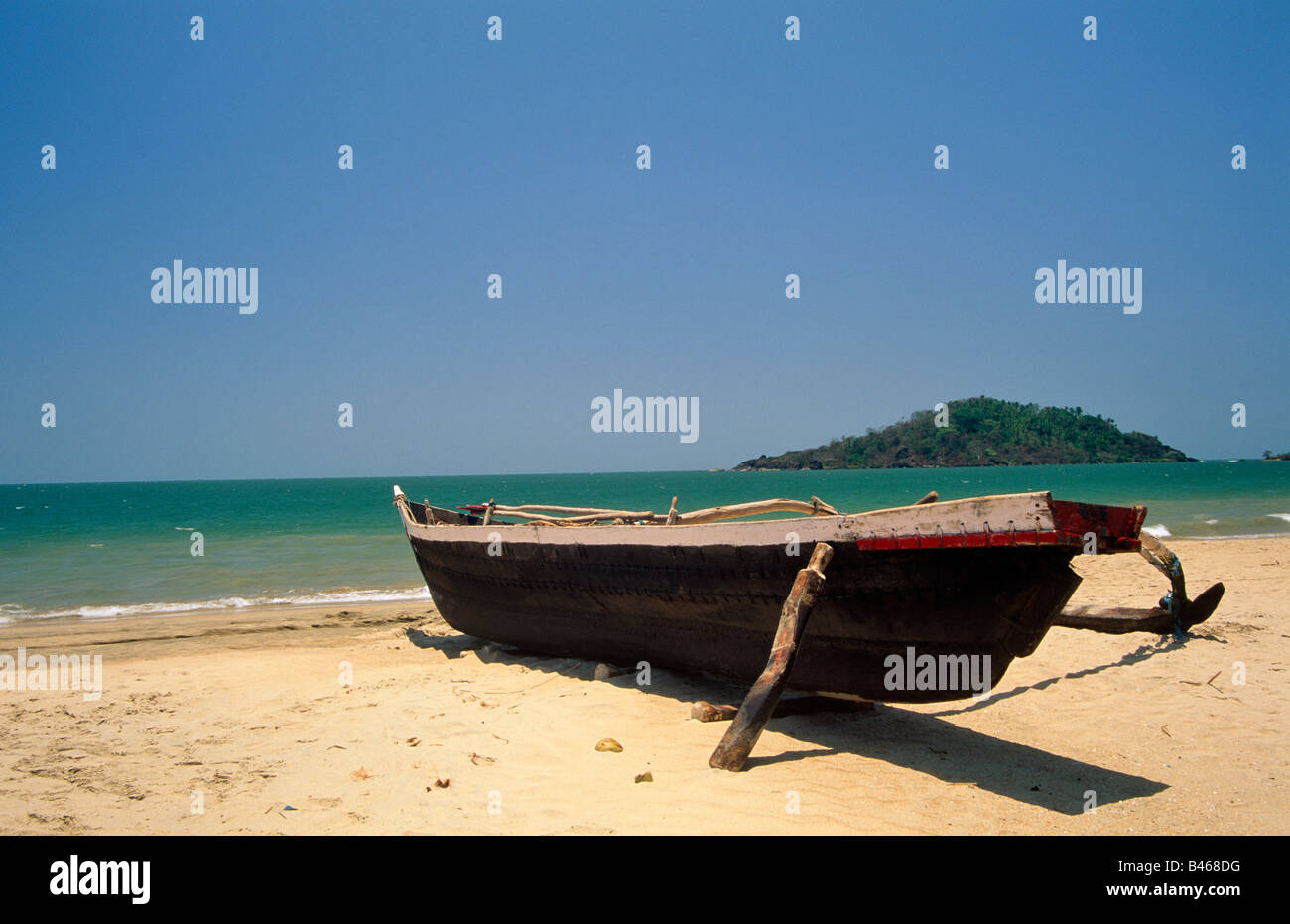 Golden sandy beach Fishing boat on land Sea Island in distance PALOLEM ...