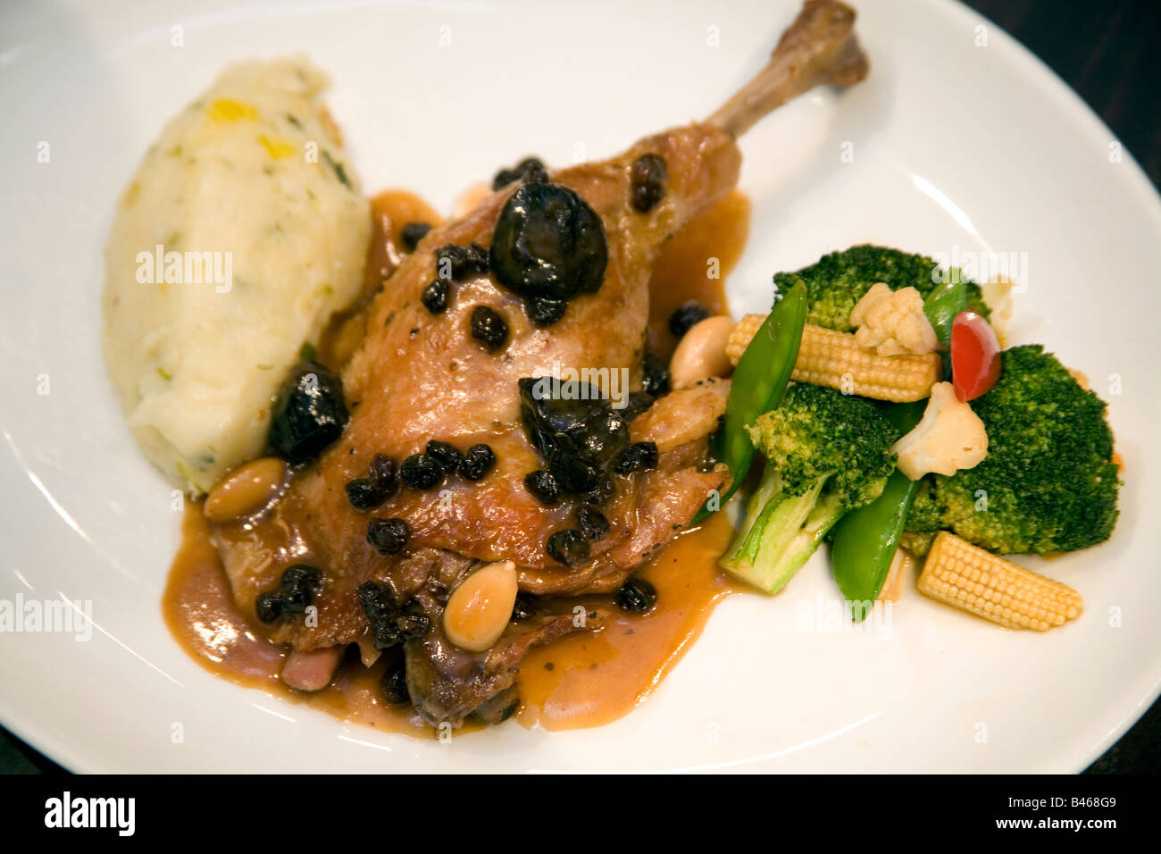 Honey glazed roasted duck leg with dried fruit Stock Photo - Alamy