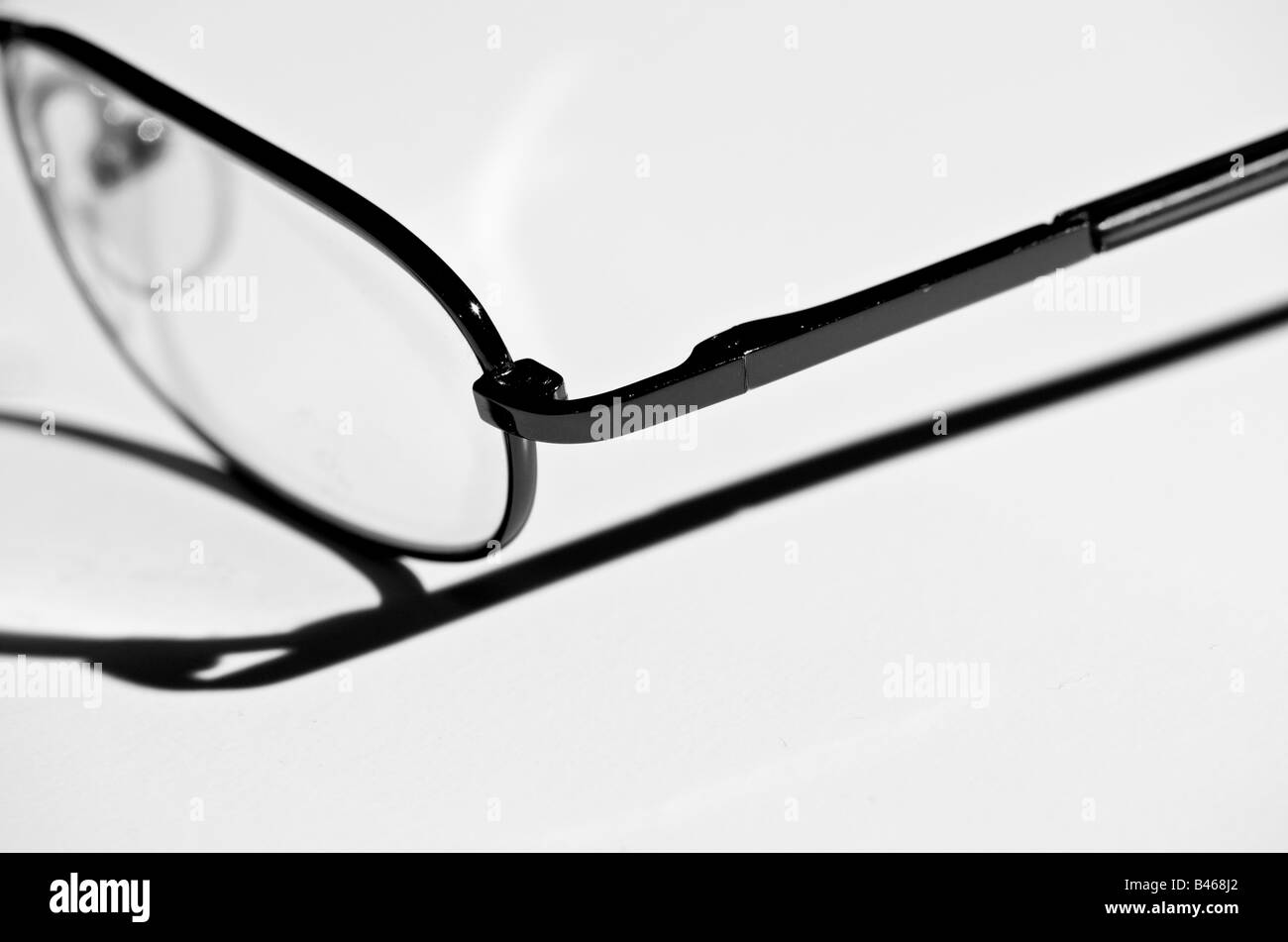 black rimmed glasses on a white table Stock Photo - Alamy