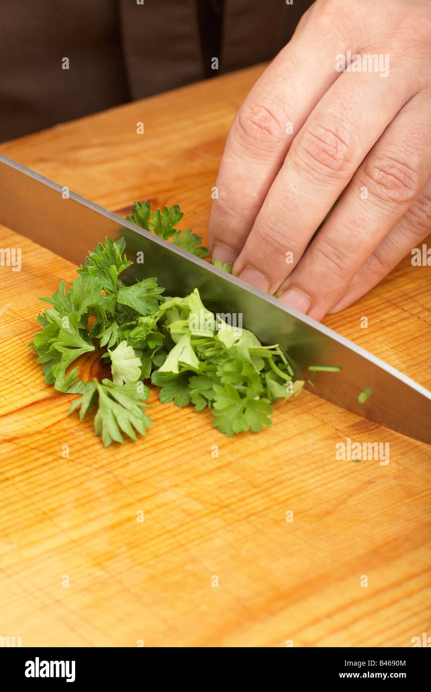 Chopping parsley, close-up Stock Photo - Alamy