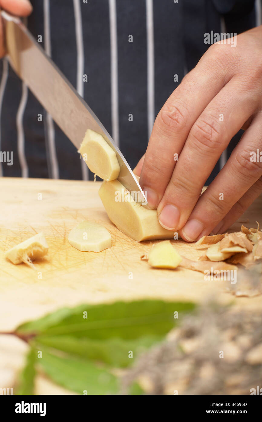 Person slicing ginger root, close-up Stock Photo - Alamy