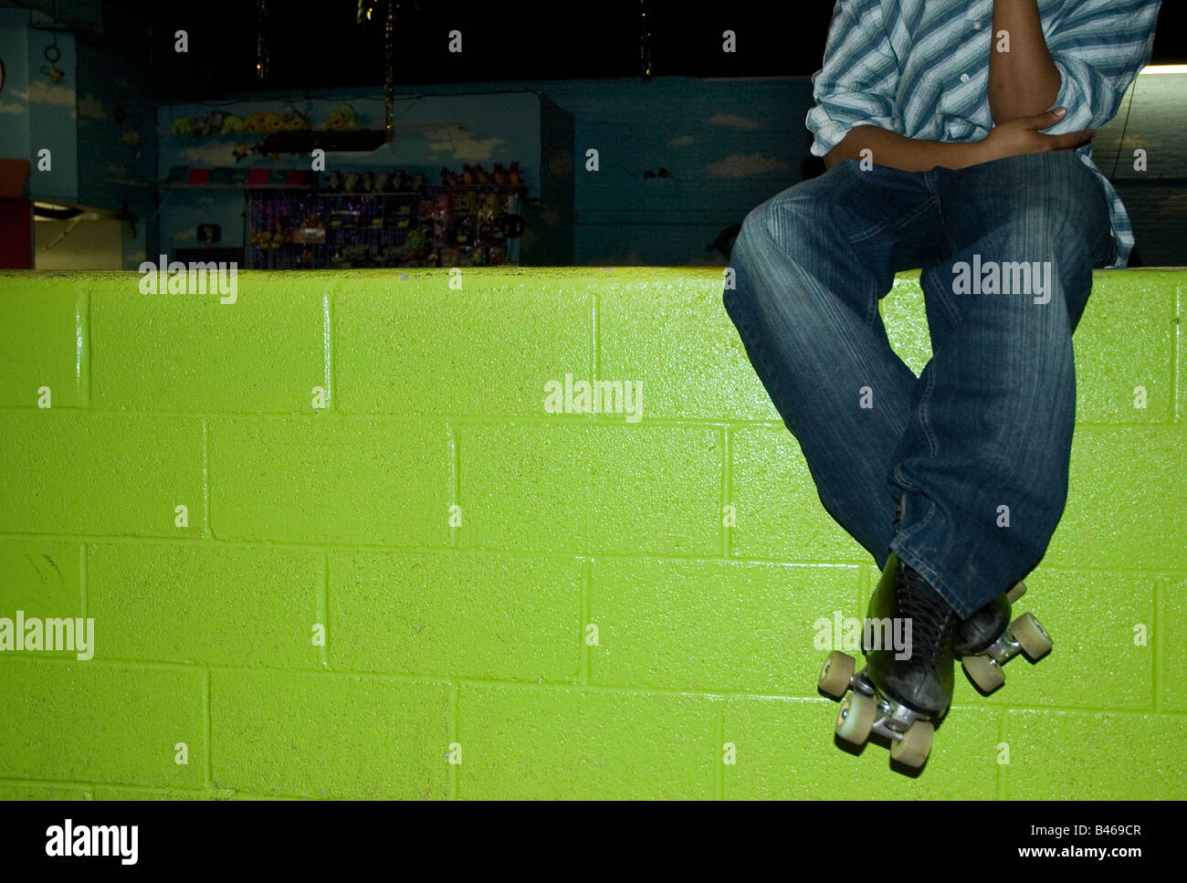 A skater at a Brooklyn roller rink takes a rest on the wall Stock Photo ...