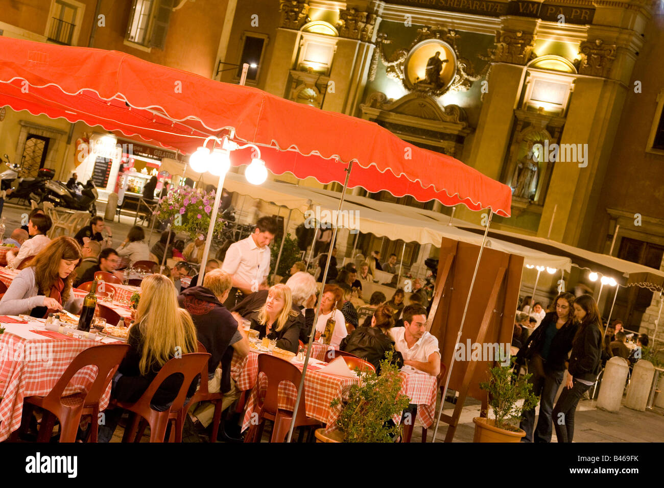 France, Cote d'Azur, Nice, Guests in restaurant out of doors at night ...