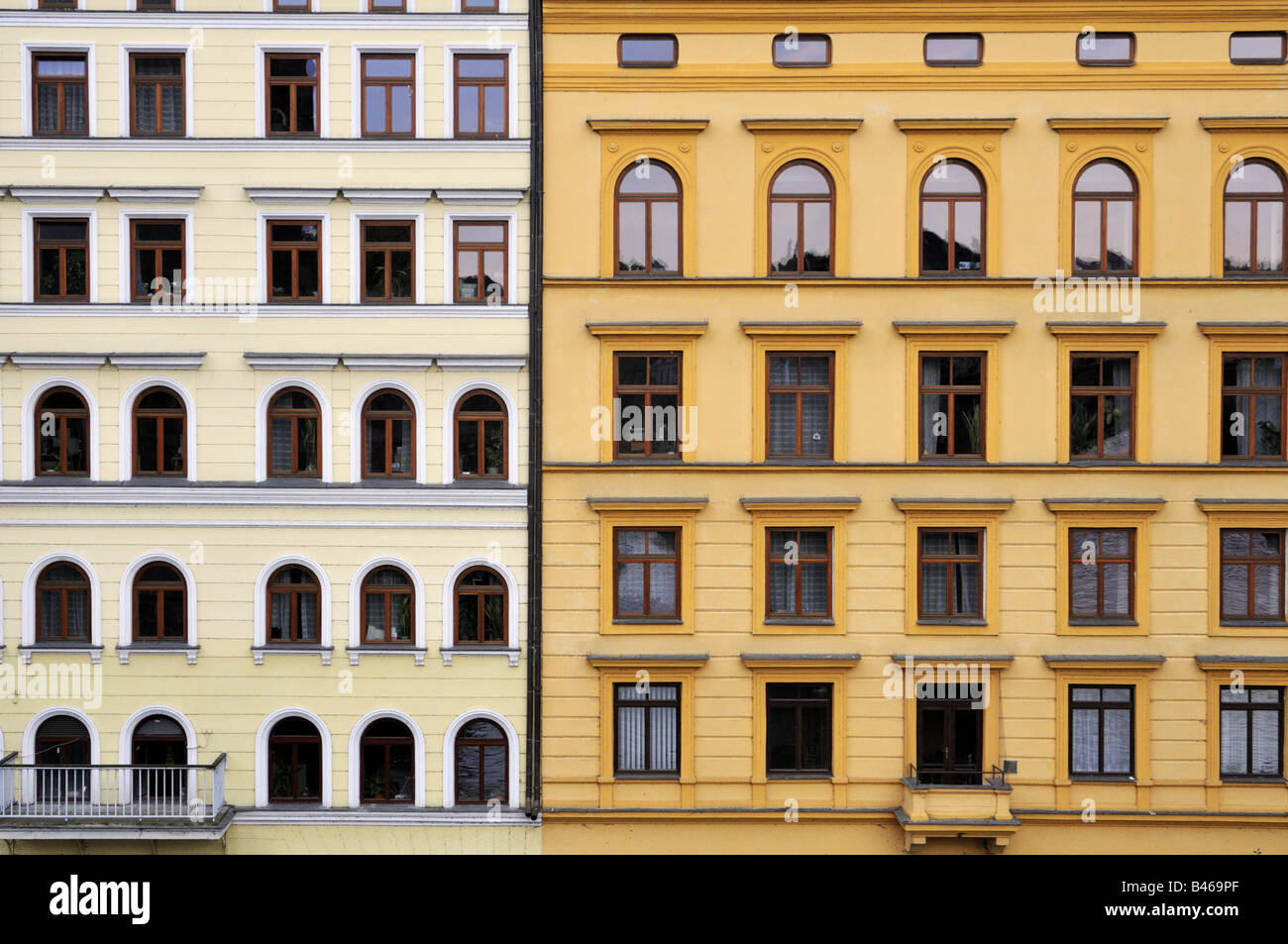 Arch and recangular windows of bright coloured buildings in Prague ...