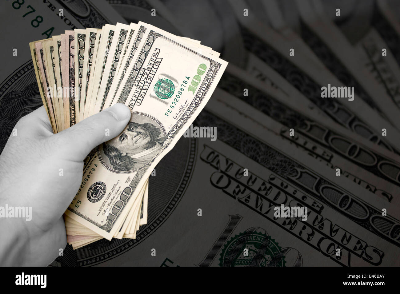 A handful of cash isolated over a gold background Stock Photo - Alamy